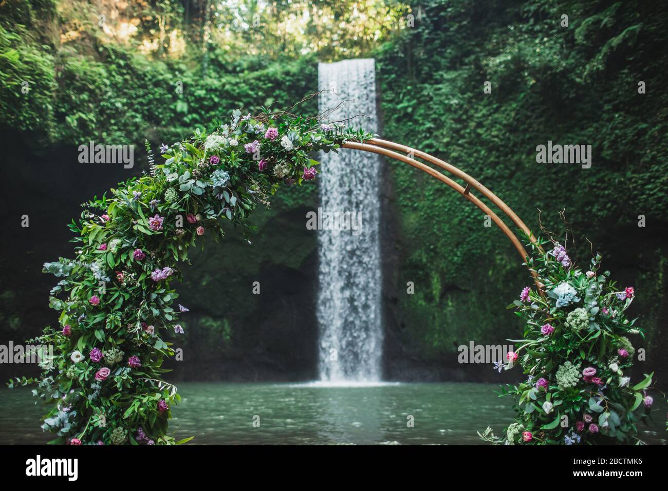 Round bronze wedding arch decorated with pink roses and greens. Unusual ...