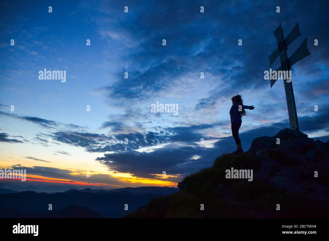 Alone woman and sunset in mountains Stock Photo - Alamy