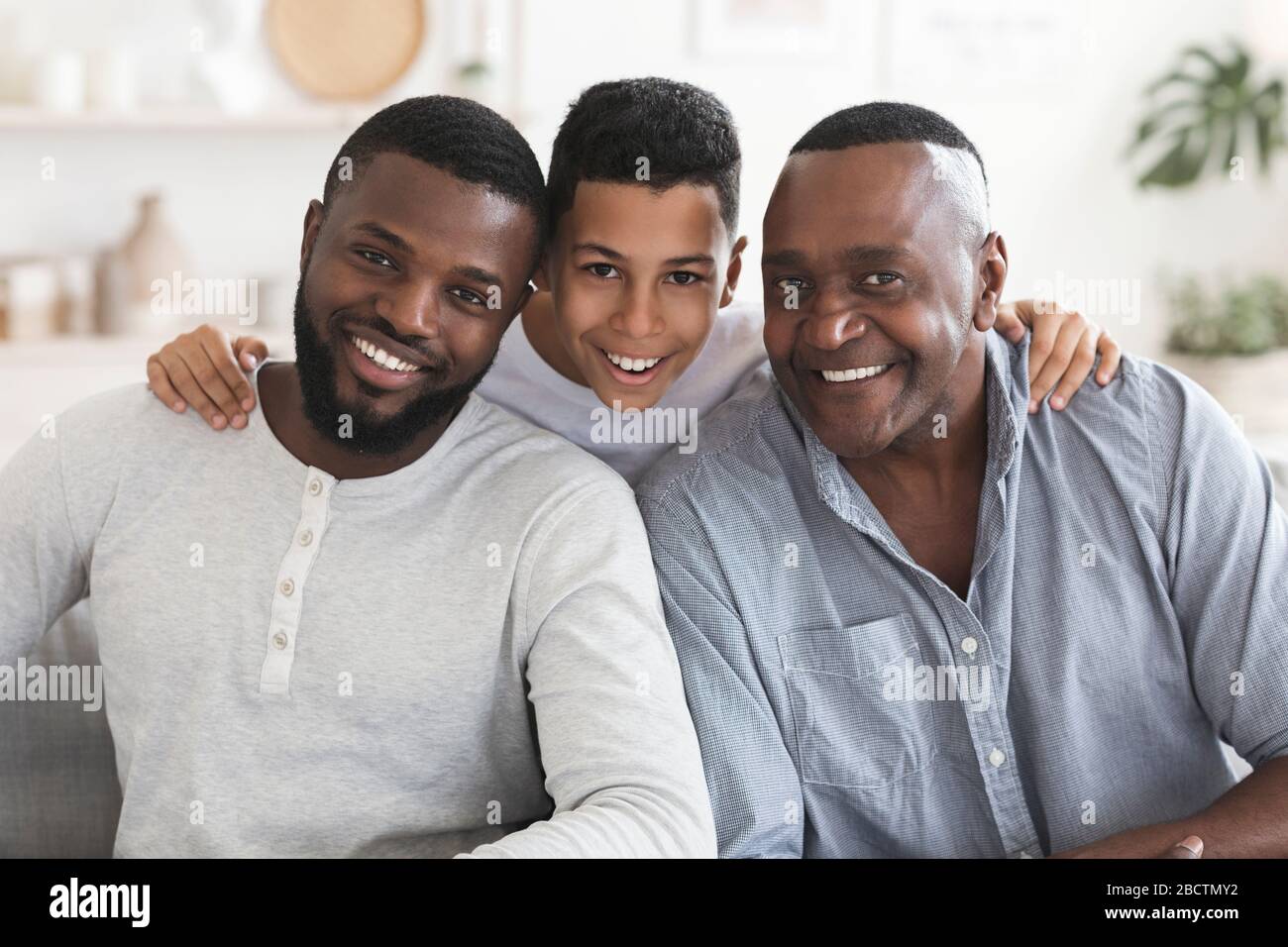 Happy black son, father and grandfather posing for family picture ...