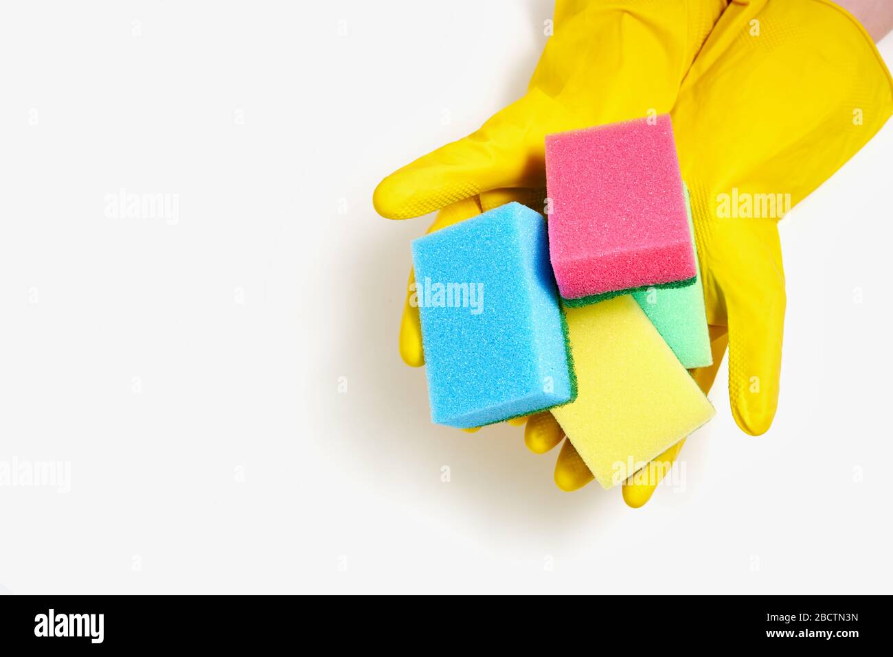 Hand holding sponge on isolated white background Stock Photo - Alamy