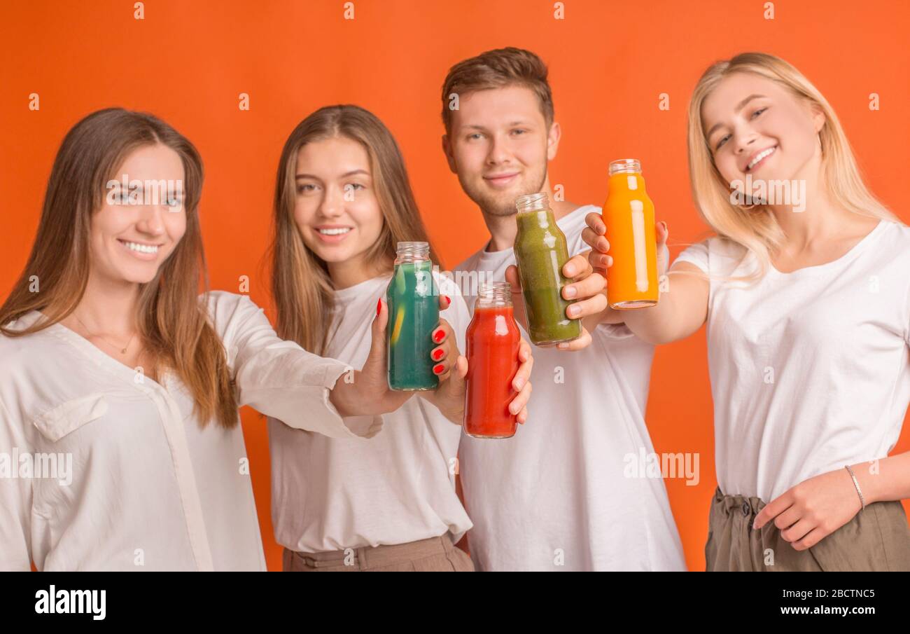 Company of teens celebrating with healthy detox drinks Stock Photo - Alamy