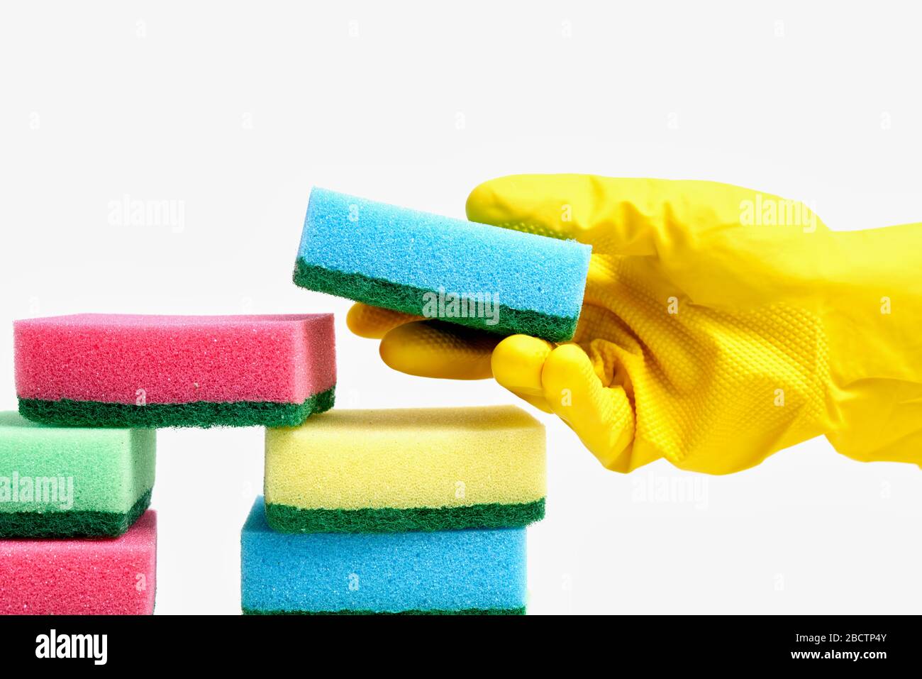 Hand holding sponge on isolated white background Stock Photo - Alamy