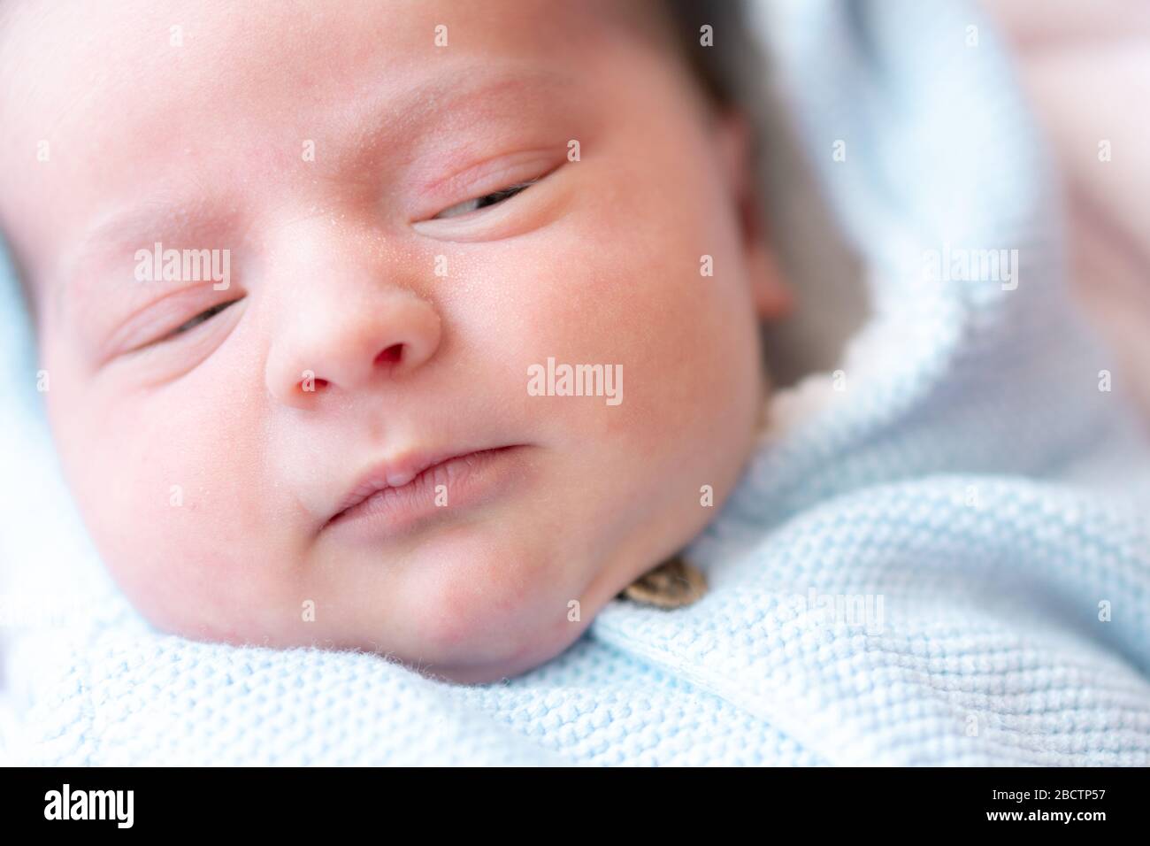 Close up portrait of a newborn baby. Close-up face of newborn baby with ...