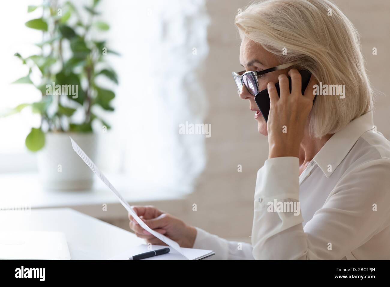Older woman on phone angry hi-res stock photography and images - Alamy