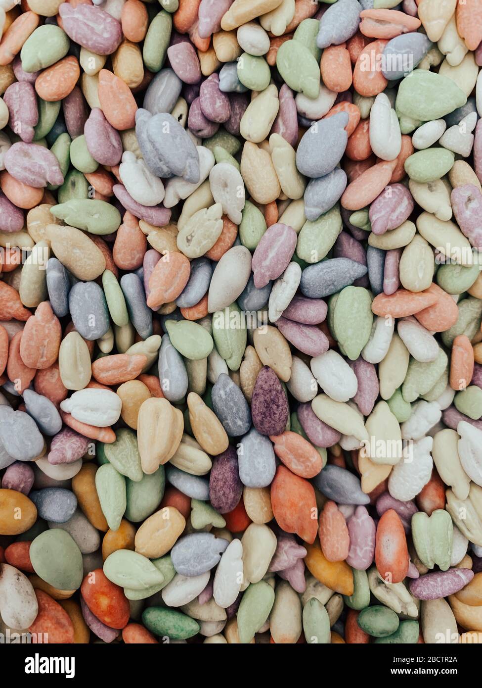 lots of multi-colored sunflower seeds for eating background Stock Photo ...