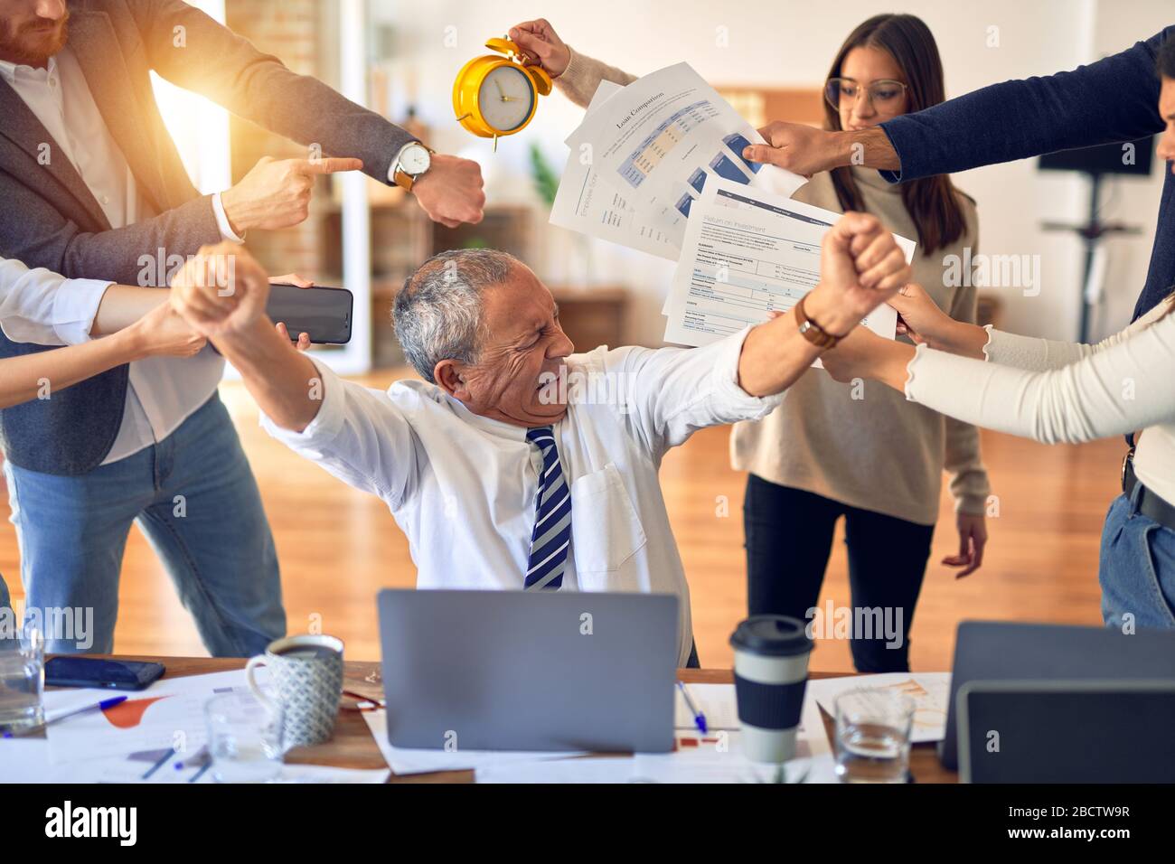 Group of business workers working together. Partners stressing one of ...
