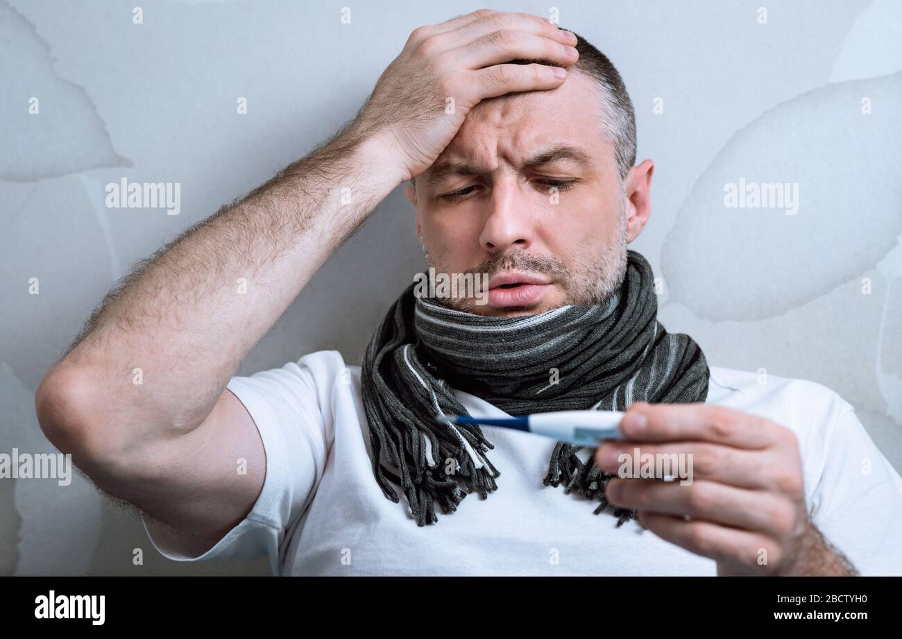 Man Having Fever Measuring Temperature Lying In Bed At Home Stock Photo ...