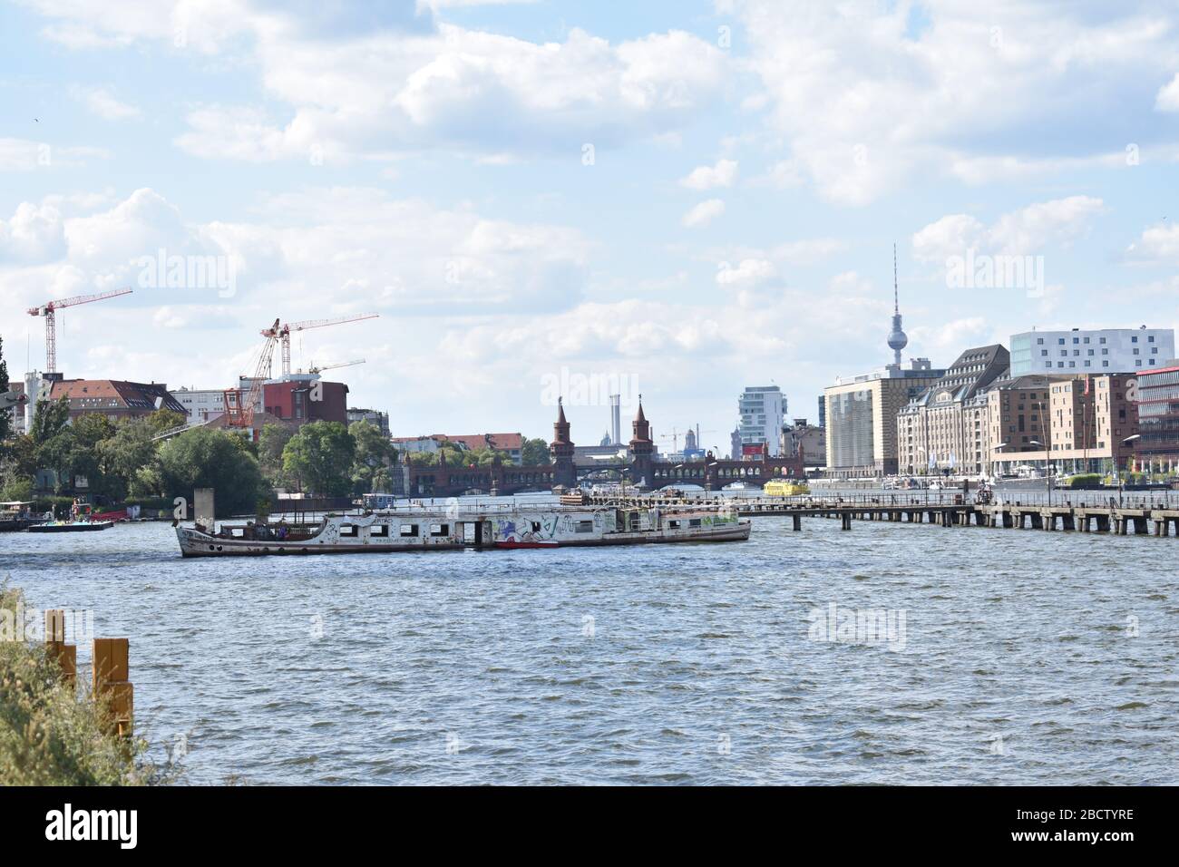 Bridge and boat along the Spree river in Friedrichshain Berlin Stock ...