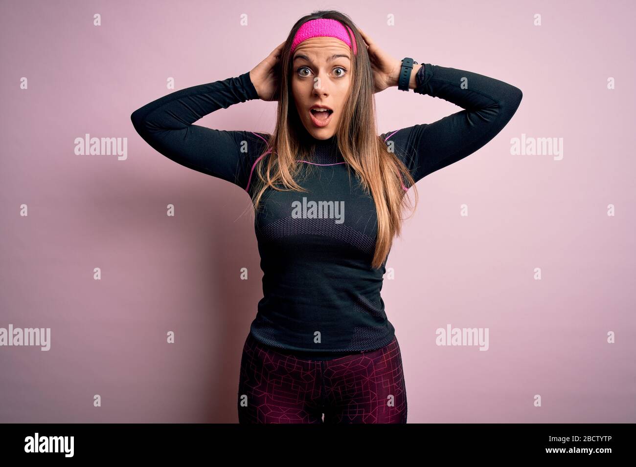 Young blonde fitness woman wearing sport workout clothes over isolated ...