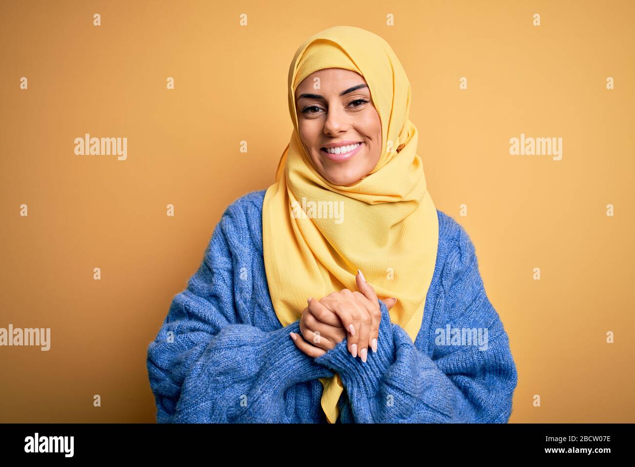 Young beautiful brunette muslim woman wearing arab hijab over isolated ...