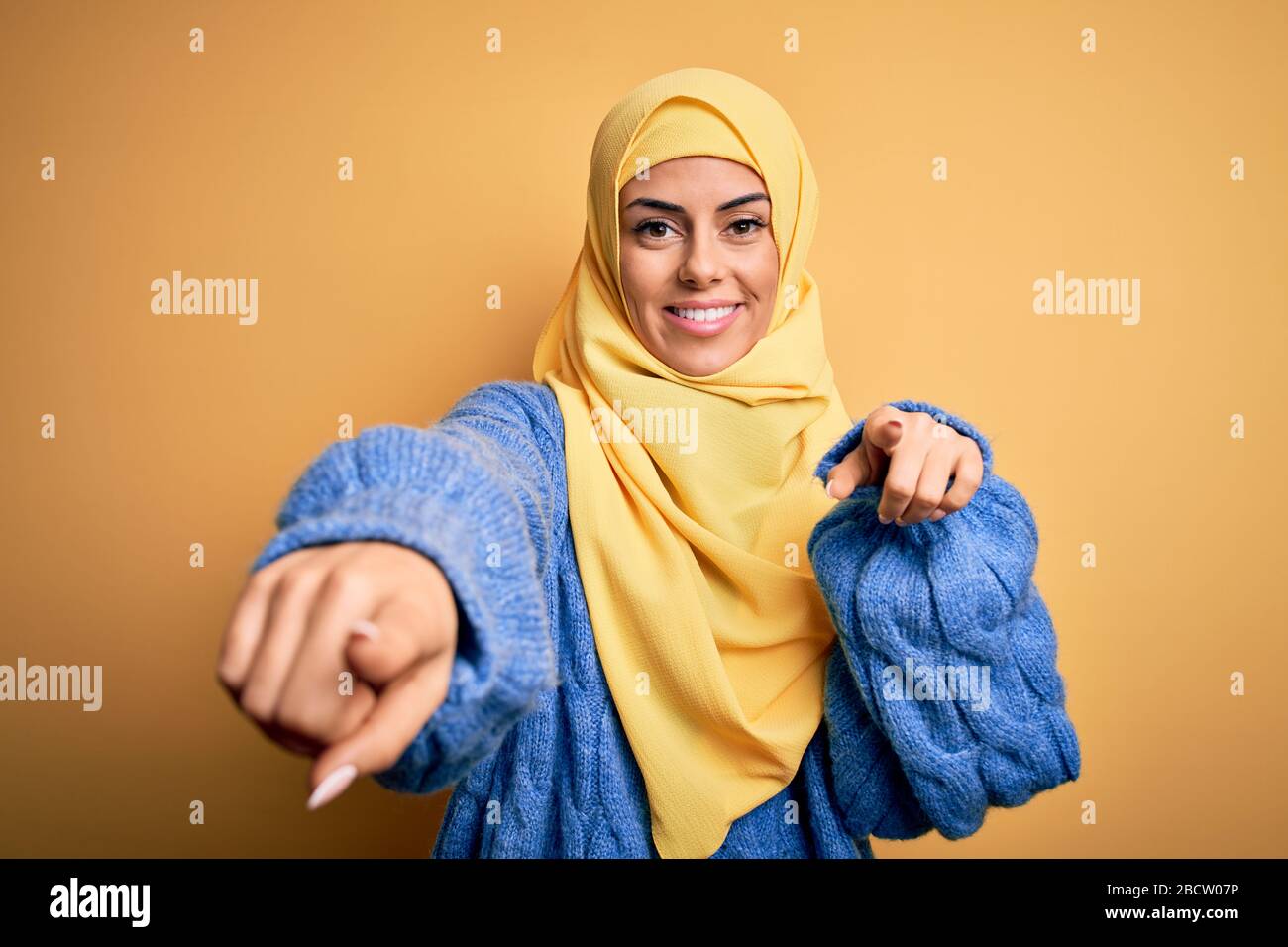 Young beautiful brunette muslim woman wearing arab hijab over isolated ...