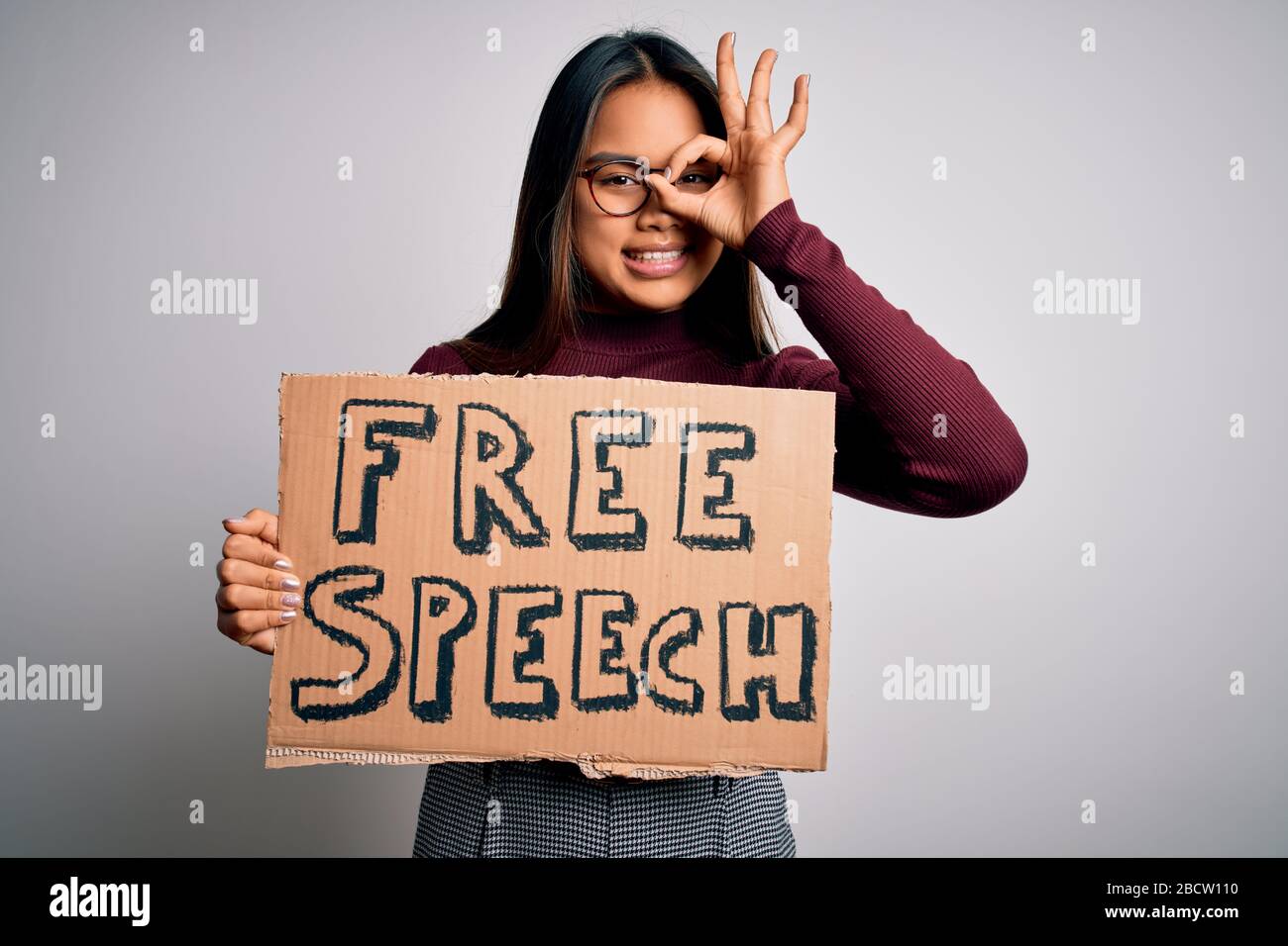 Asian girl asking for rights holding banner with free speech message ...