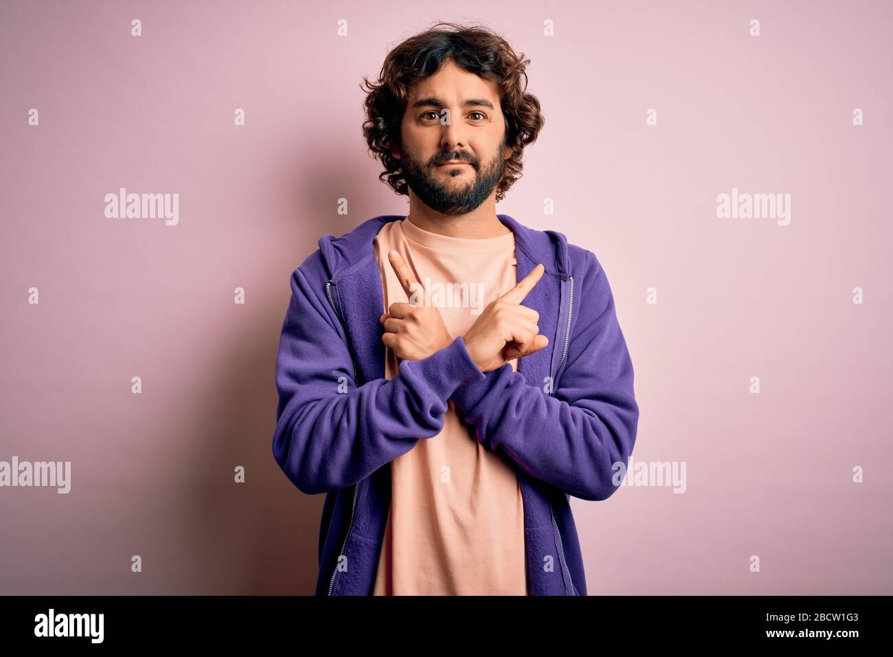 Young handsome sporty man with beard wearing casual sweatshirt over ...