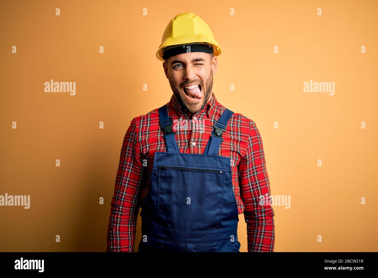 Young builder man wearing construction uniform and safety helmet over ...