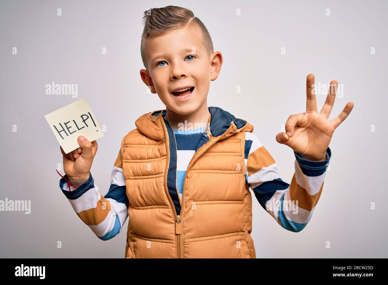 Young little caucasian kid asking for help on a paper note as violence ...
