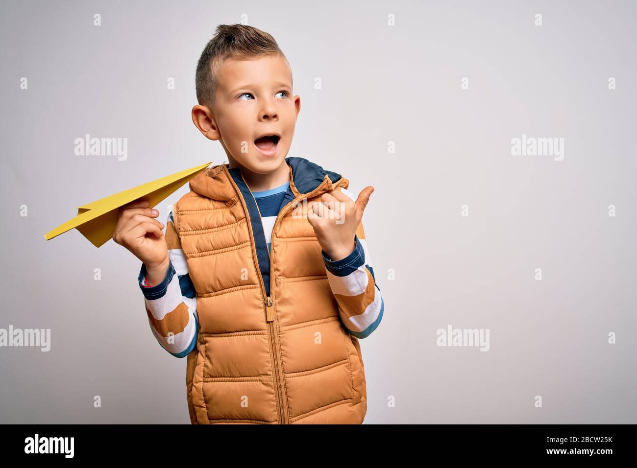 Young little caucasian kid having fun and playing imagination fly with ...