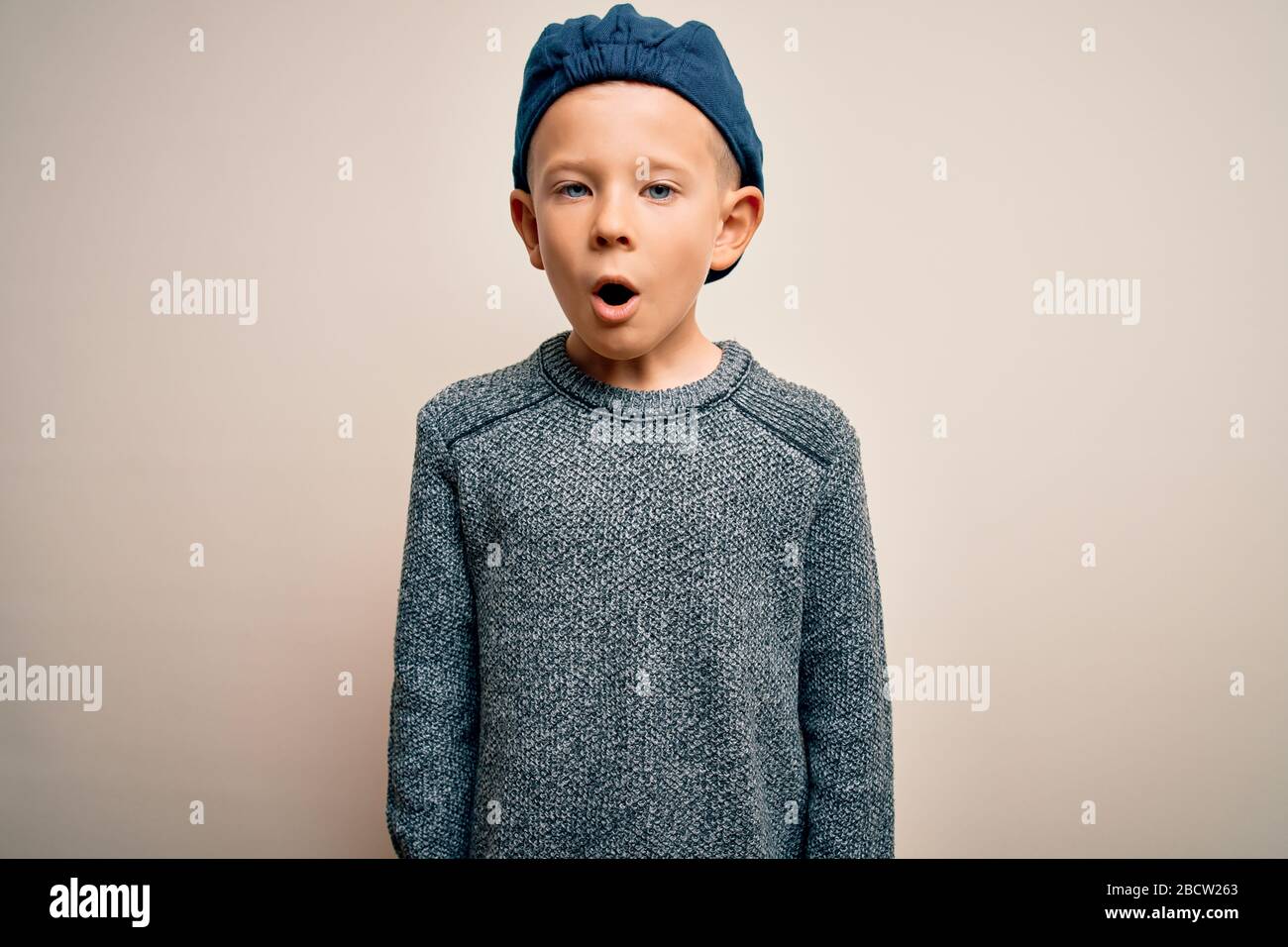 Young little caucasian kid with blue eyes wearing wool cap over ...