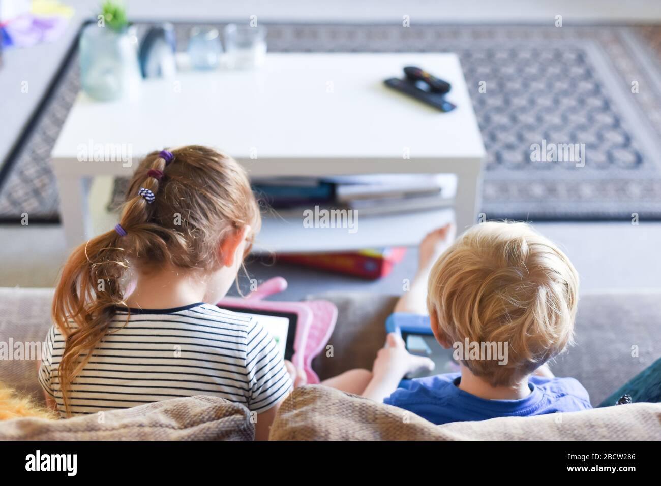 Children using their tablet device to play computer games and use ...