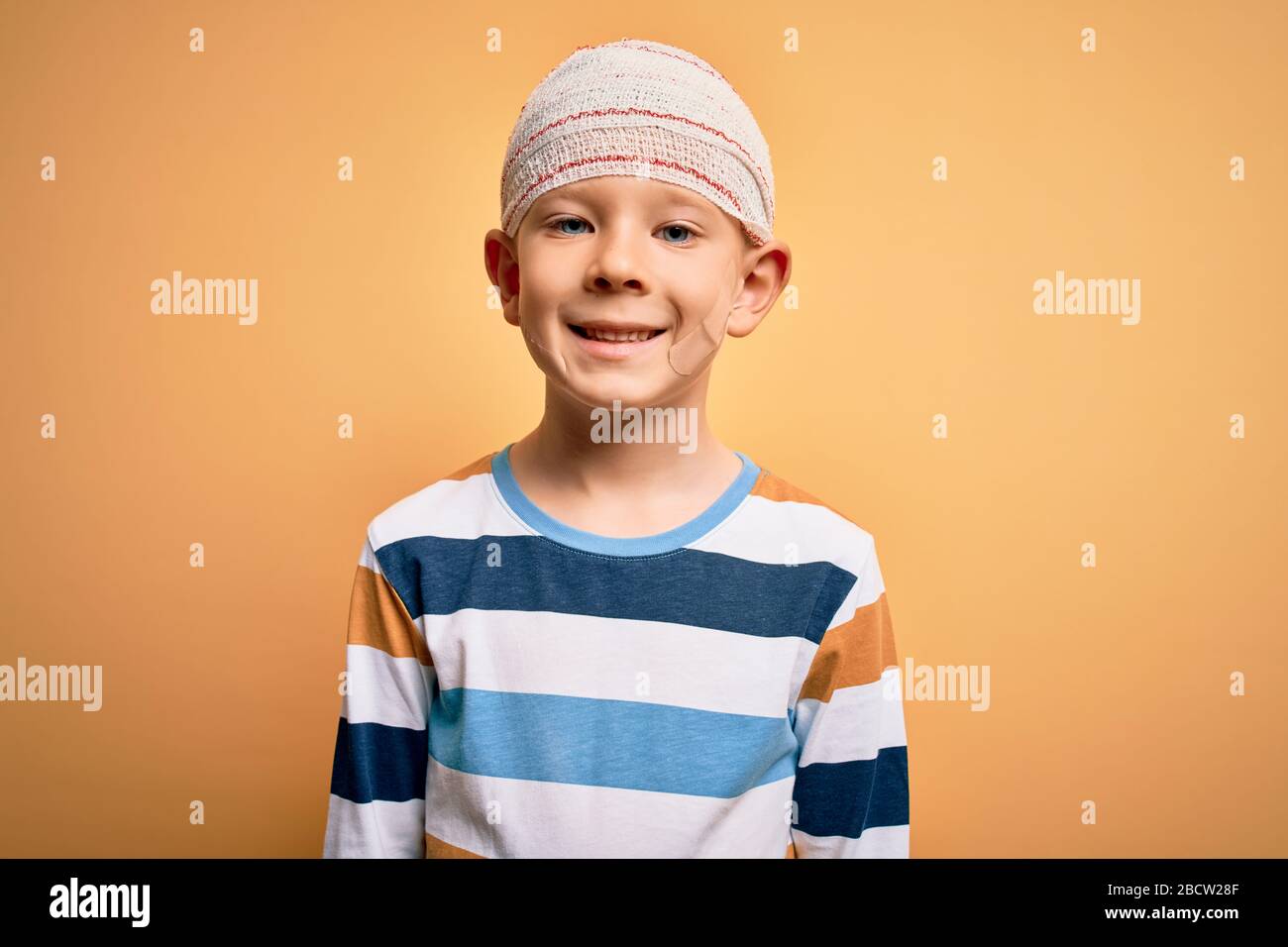 Young little caucasian kid injured wearing medical bandage on head over ...