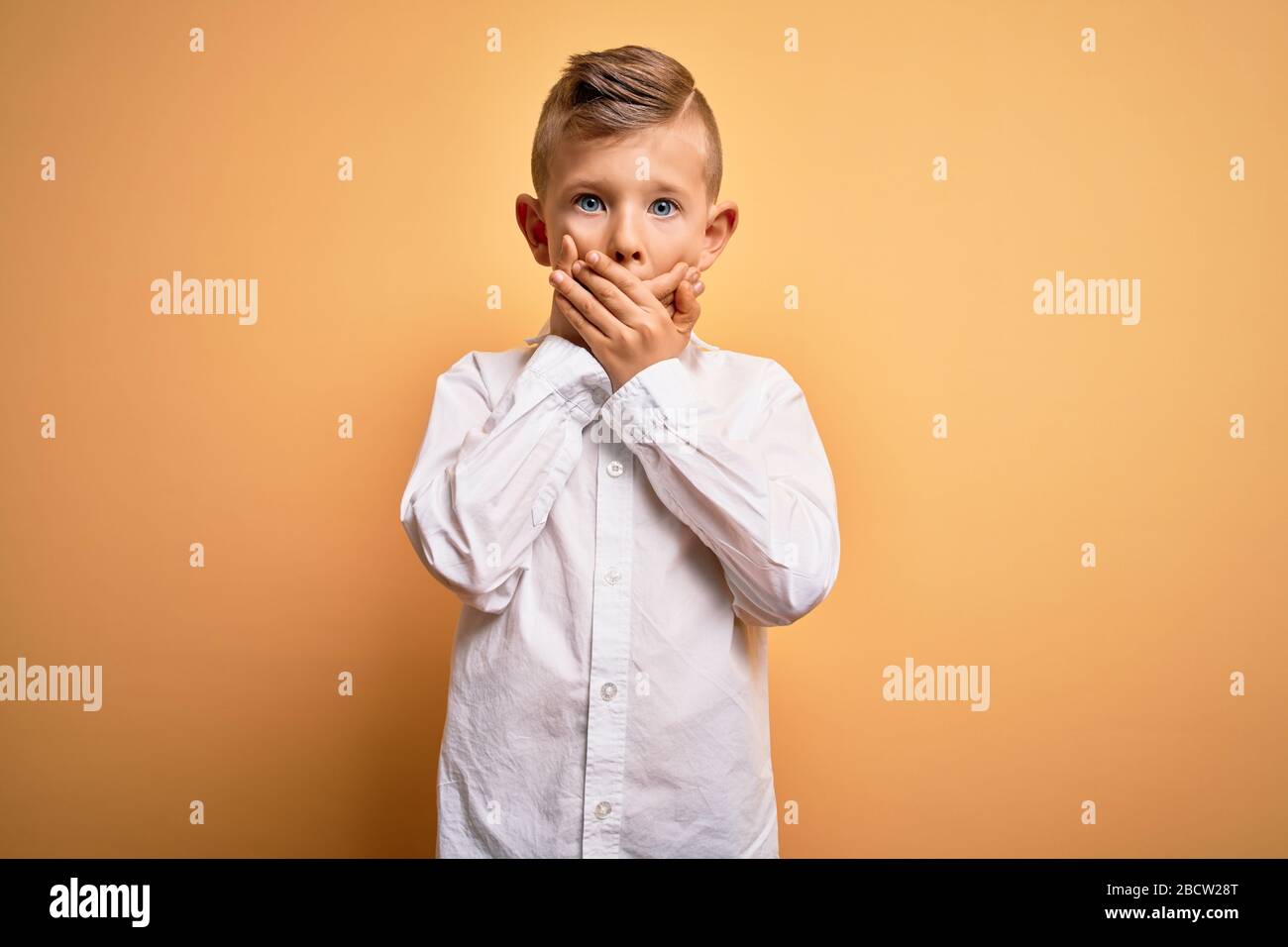 Young little caucasian kid with blue eyes wearing elegant white shirt ...
