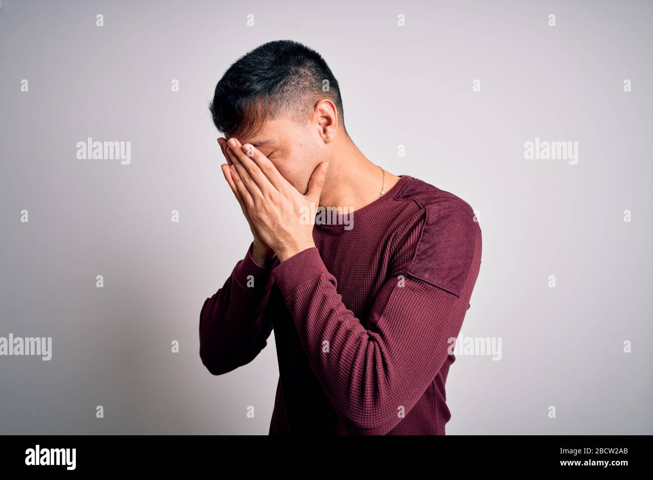 Young handsome hispanic man wearing casual shirt standing over white ...