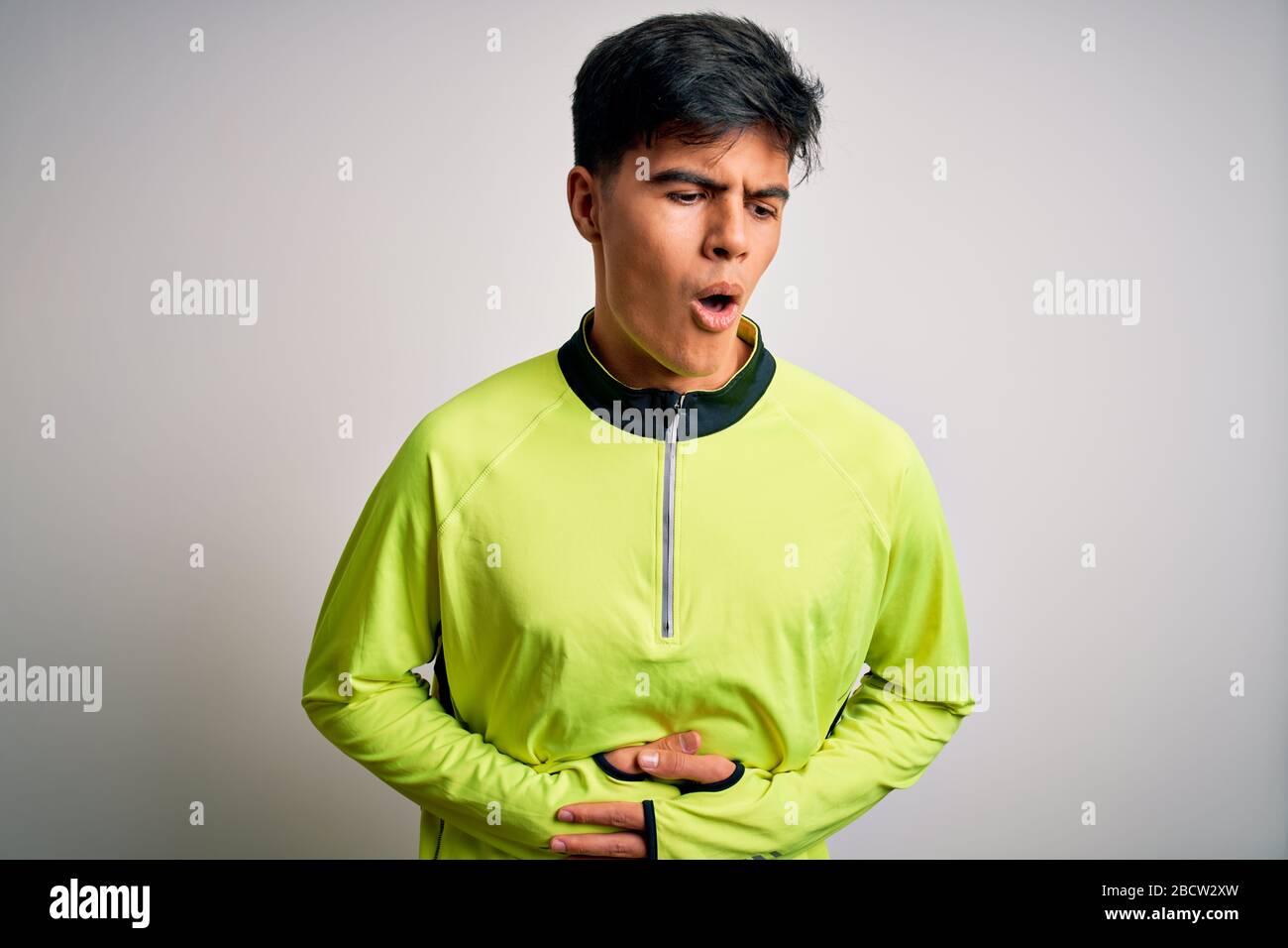 Young handsome sportsman doing sport wearing sportswear over isolated ...