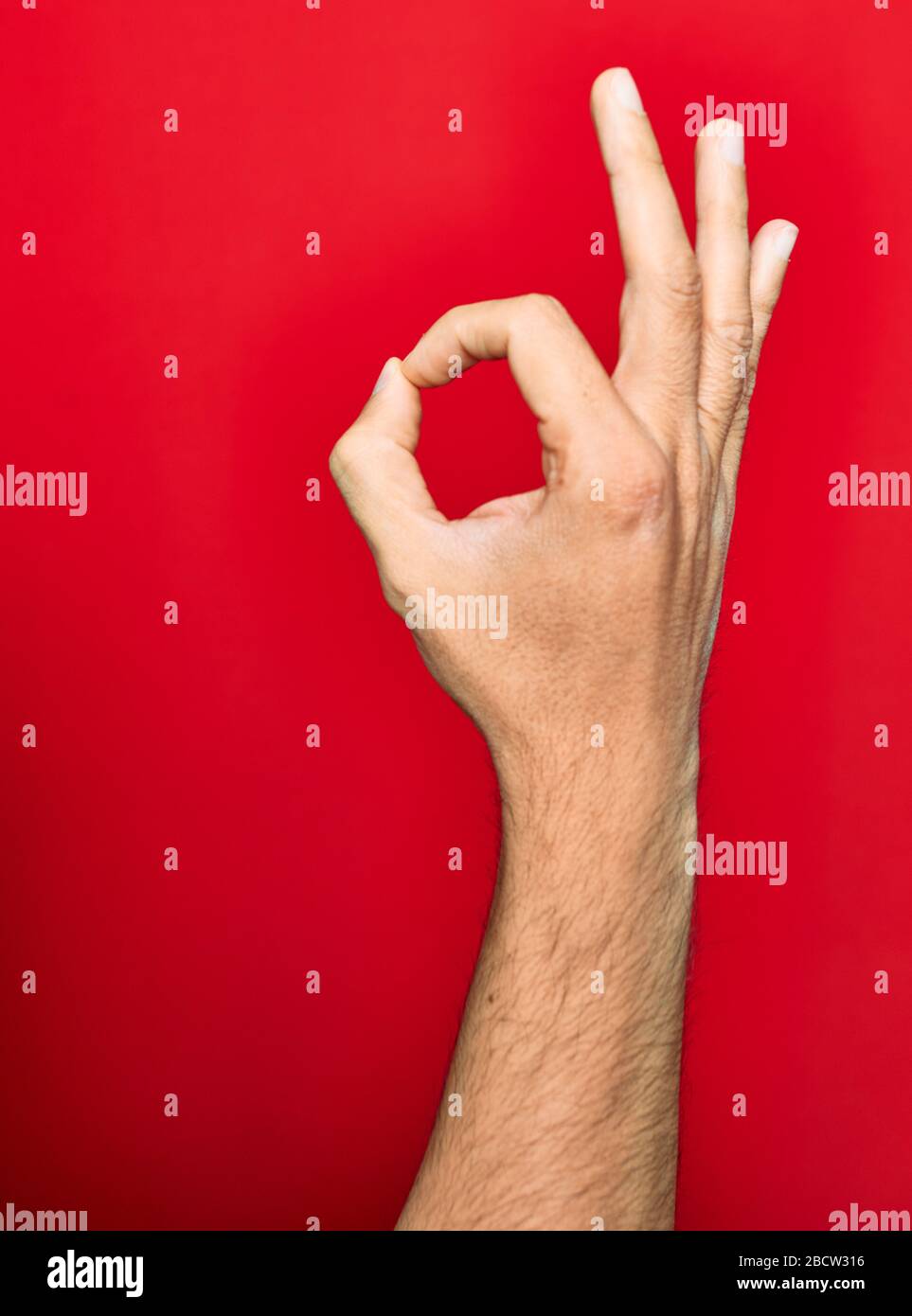 Beautiful hand of man doing okey sign Stock Photo - Alamy