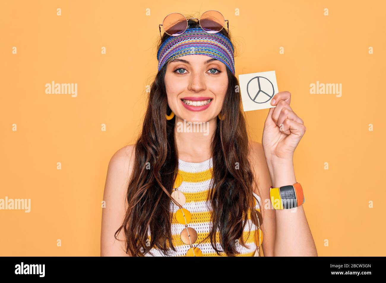 Beautiful hippie woman with blue eyes wearing sunnglasses holding peace ...