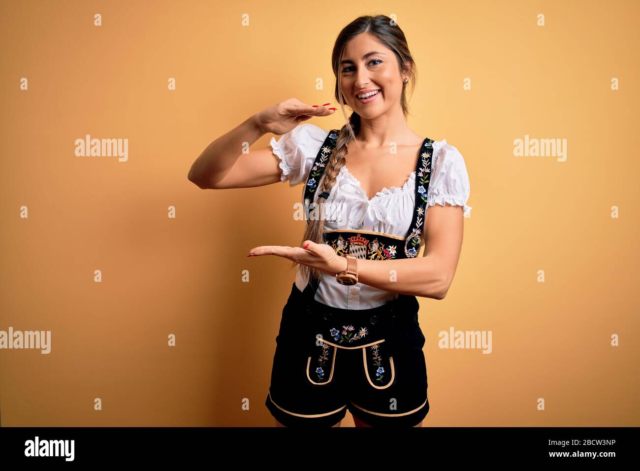 Young beautiful brunette german woman celebrating Octoberfest wearing ...