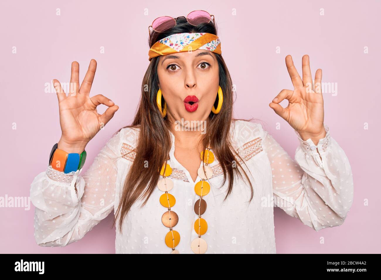 Young hispanic hippie woman wearing fashion boho style and sunglasses ...