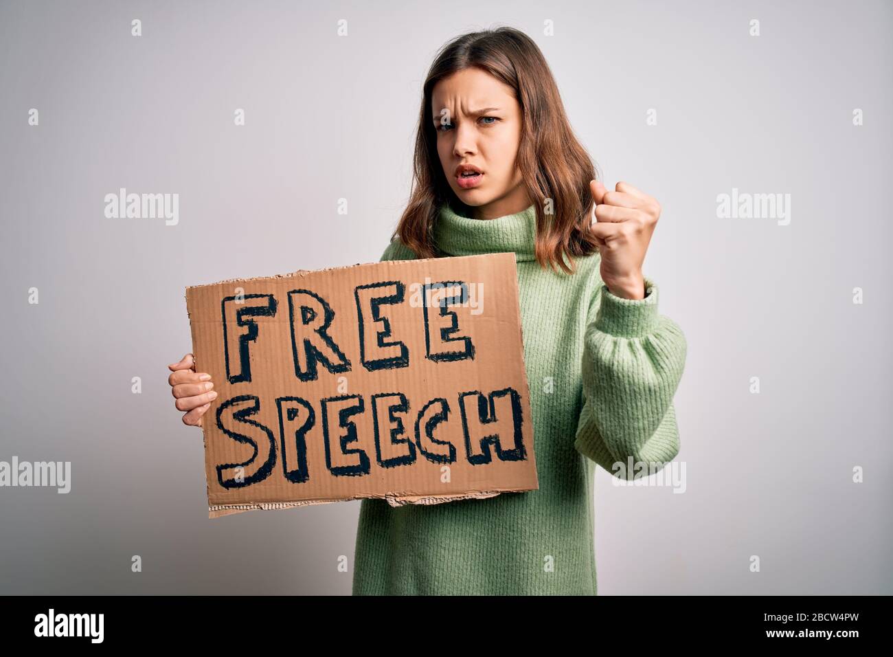 Young blonde girl holding protest banner with free speech message as ...