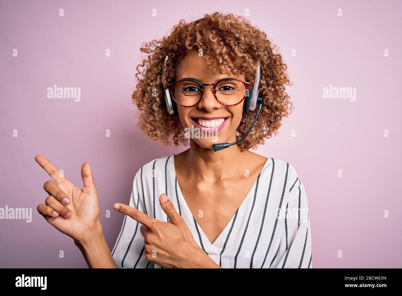 African american curly call center agent woman working using headset ...