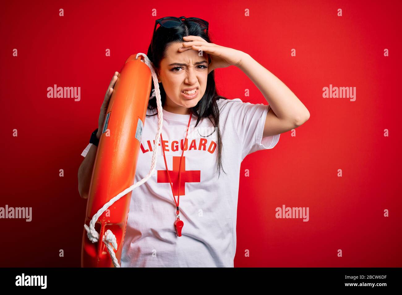 Young lifeguard woman wearing secury guard equipent holding rescue ...