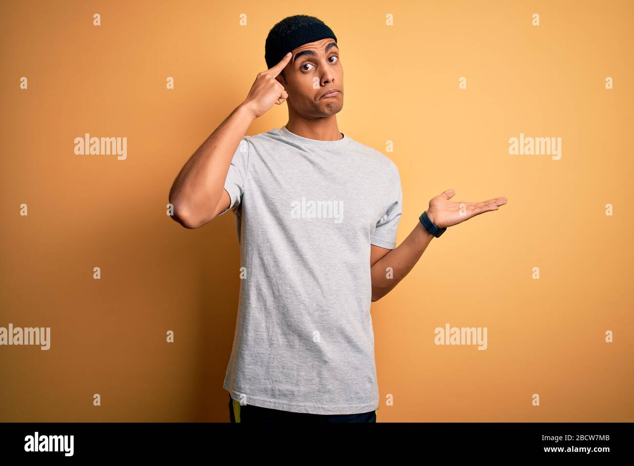 Handsome african american sportsman doing sport wearing sportswear over ...