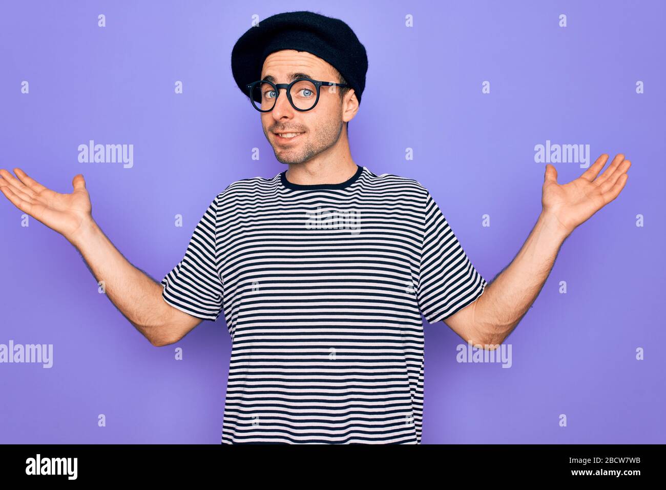 Handsome man with blue eyes wearing striped t-shirt and french beret ...