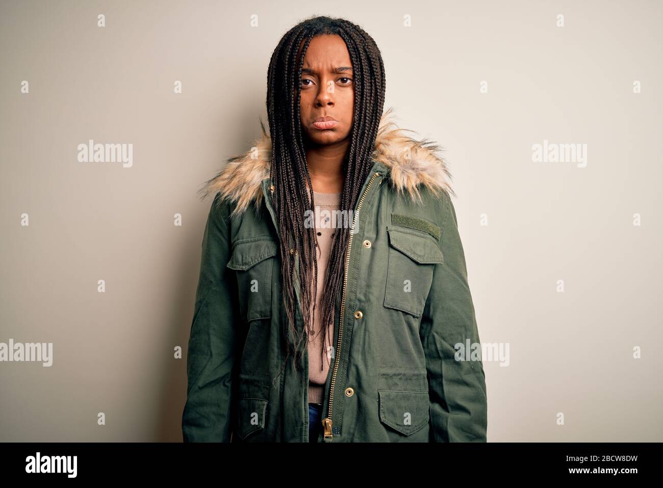 Young african american woman wearing winter parka coat over isolated ...