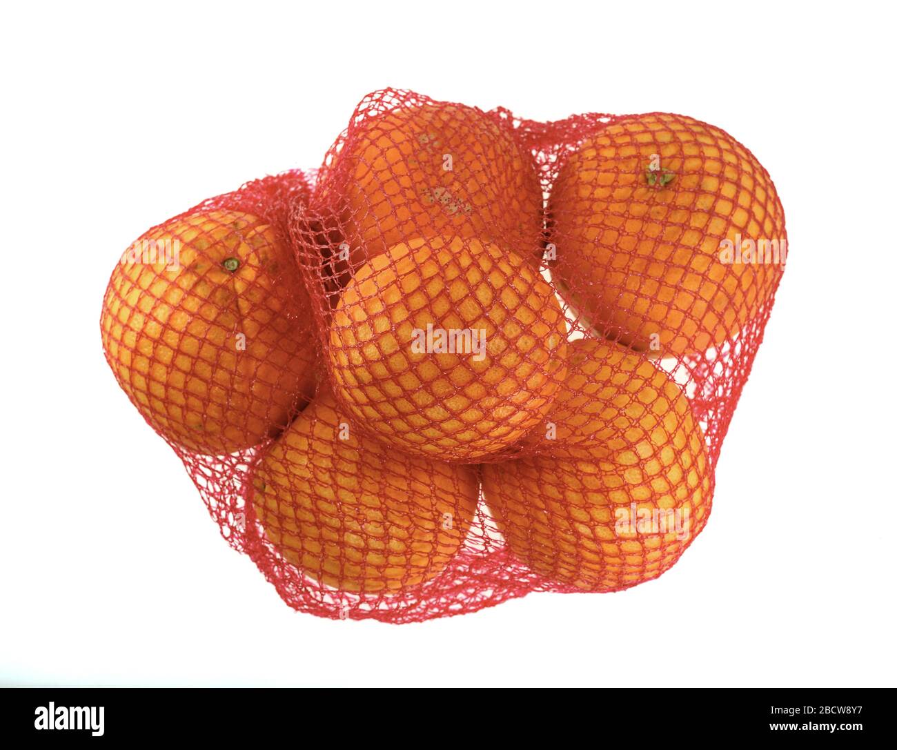 Orange in red net isolated on white background. Fresh oranges in ...