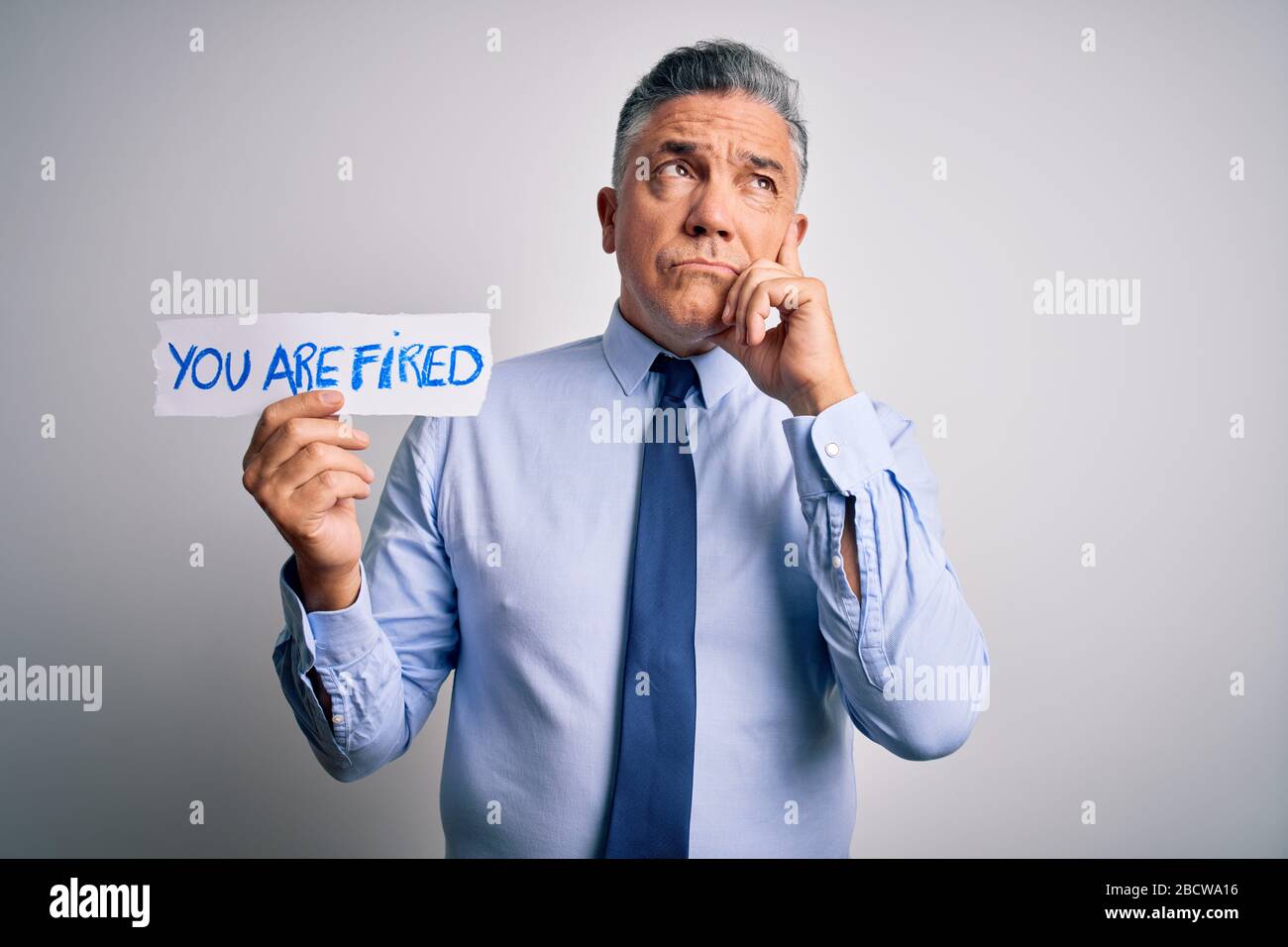 Middle age grey-haired man fired with problems holding paper with you ...