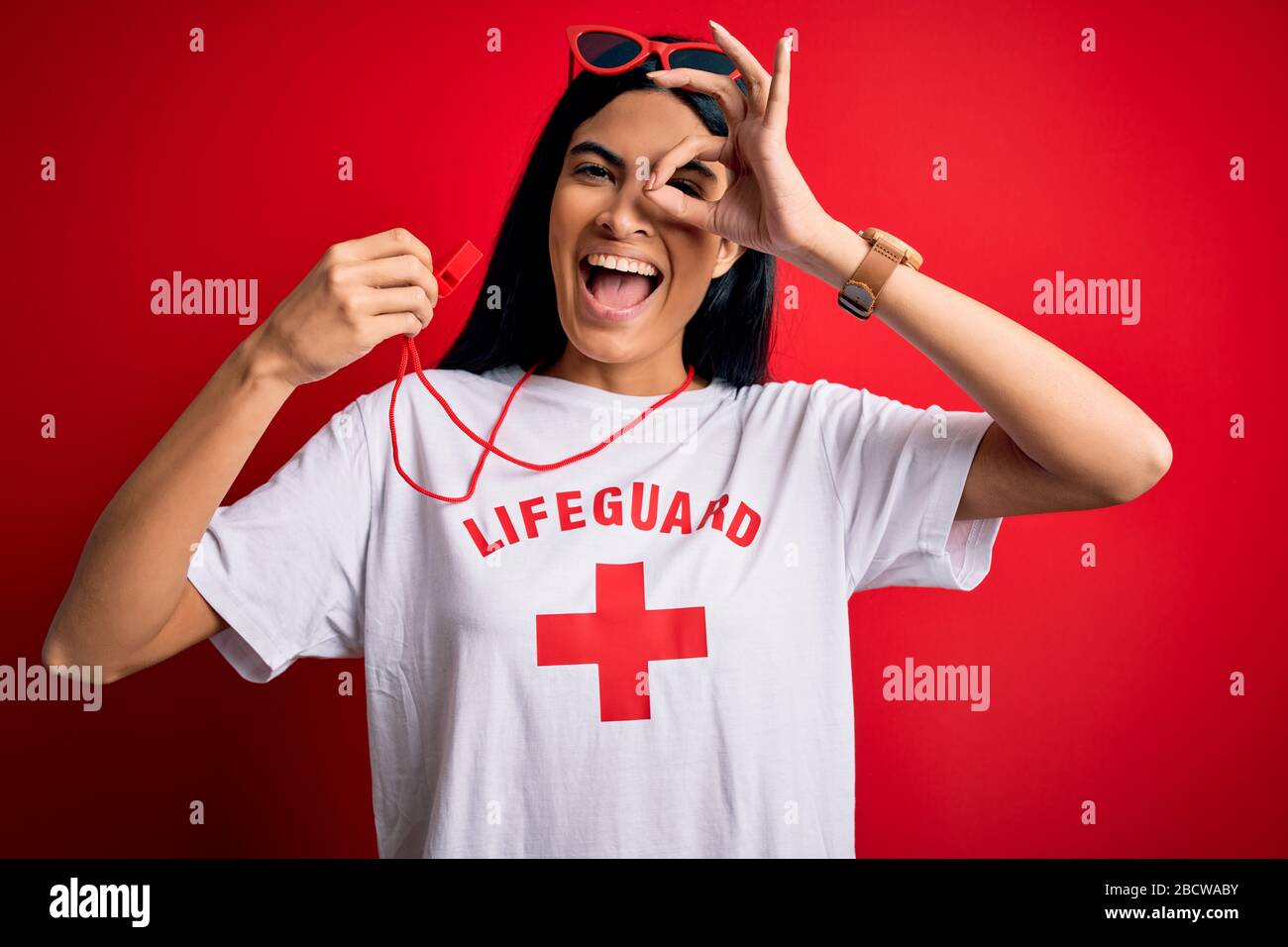 Young beautiful hispanic lifeguard woman wearing safeguard t-shirt ...