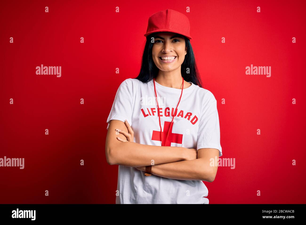 Young beautiful hispanic lifeguard woman wearing safeguard t-shirt and ...