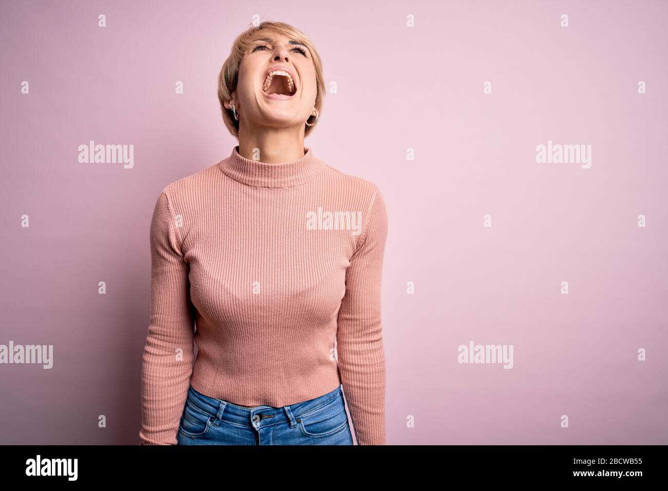 Young blonde woman with short hair wearing casual turtleneck sweater ...