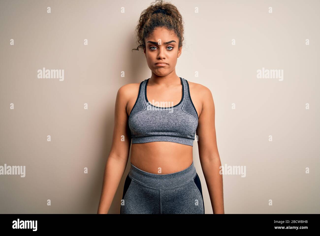 Young african american sportswoman doing sport wearing sportswear over ...