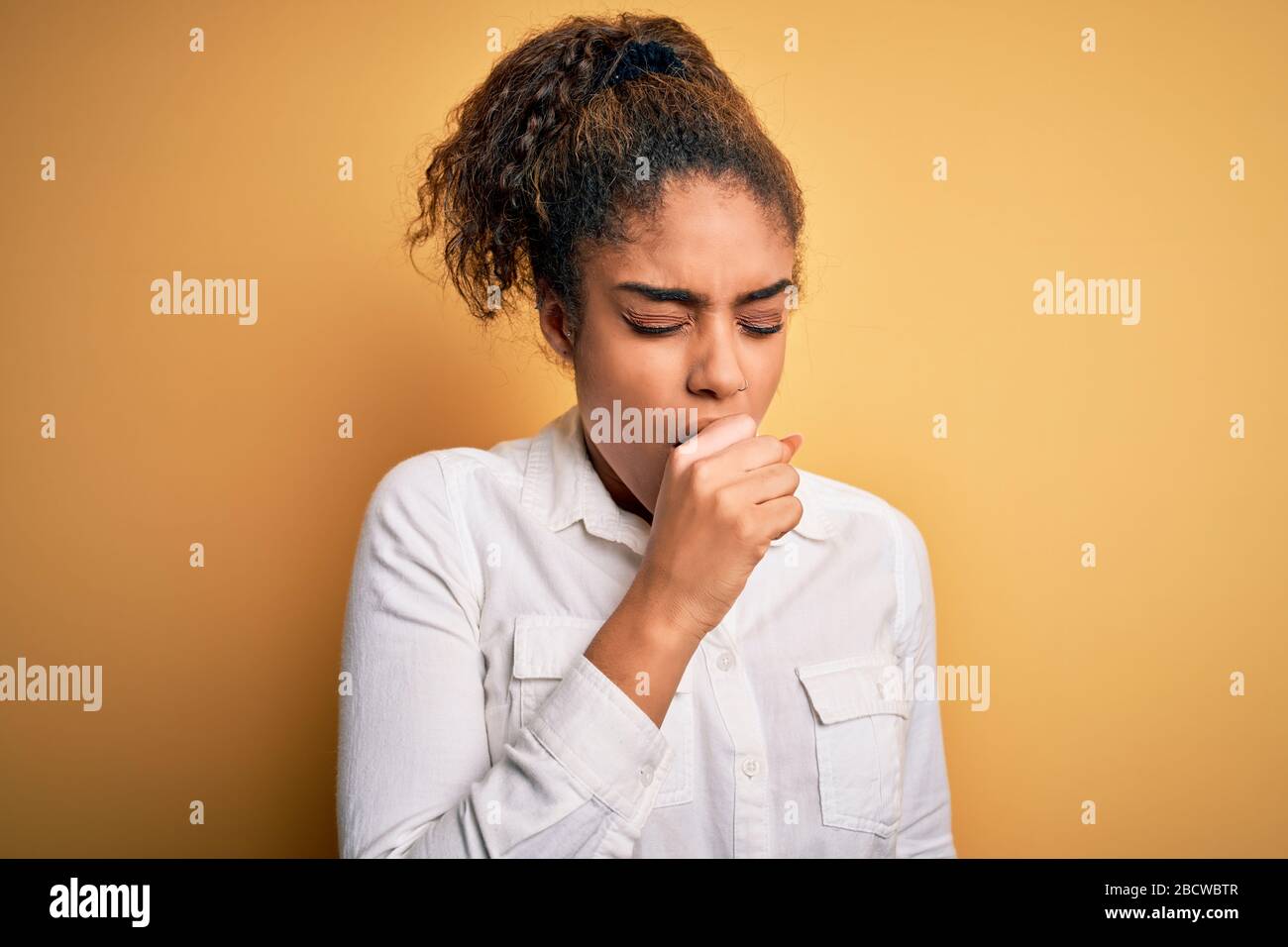 Young beautiful african american girl wearing casual shirt standing ...