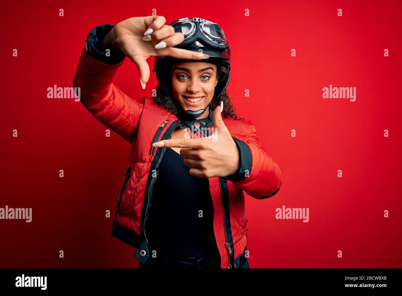 Young african american motorcyclist girl wearing moto helmet and ...