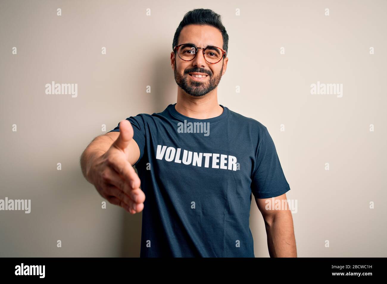 Handsome man with beard wearing t-shirt with volunteer message over ...