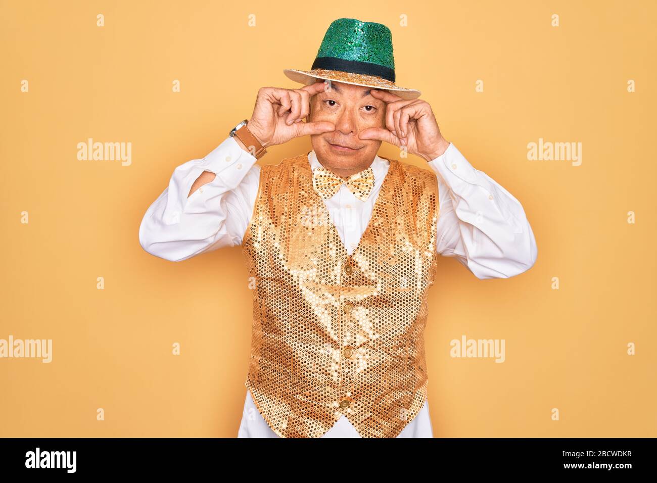 Middle age senior grey-haired man wearing Brazilian carnival custome ...