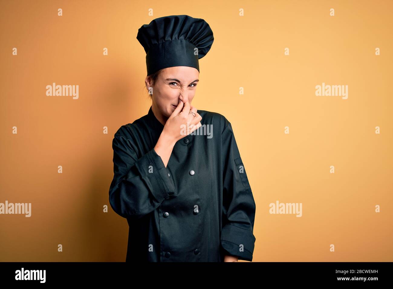 Beautiful young female chef smells hi-res stock photography and images ...