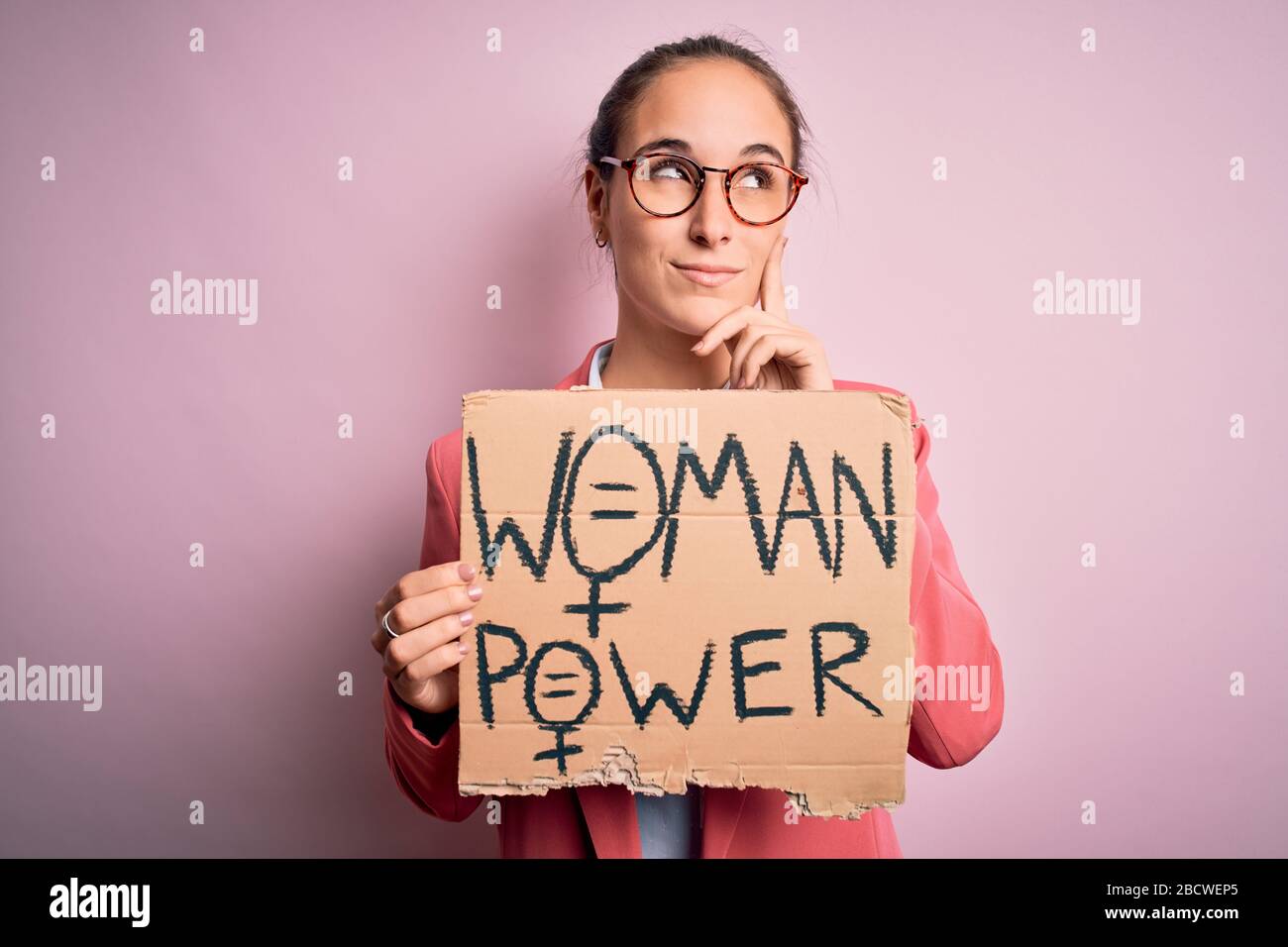 Young beautiful activist woman asking for women rights holding banner ...