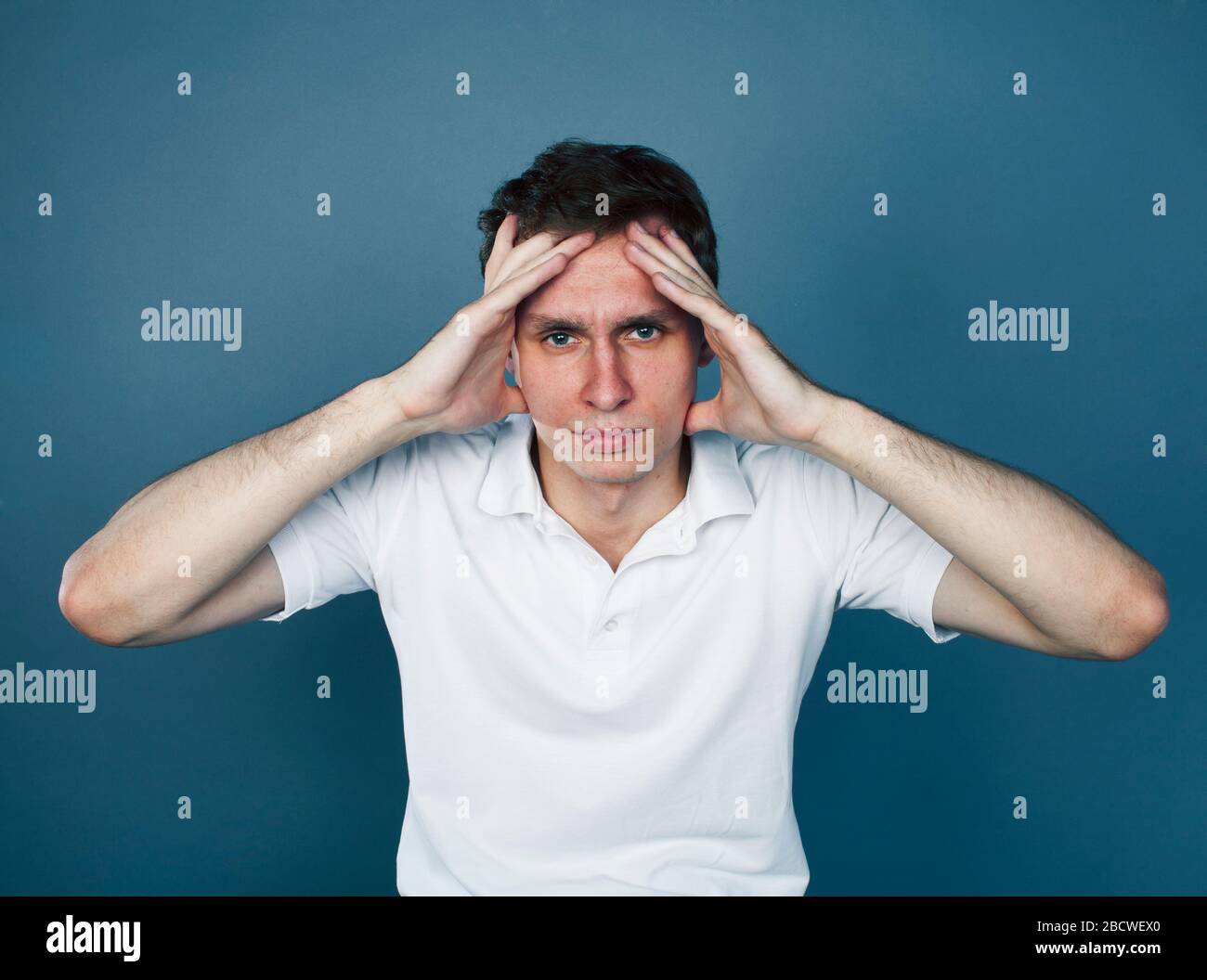 young goofy man with pimples pointing gesturing in studio, stupid ...