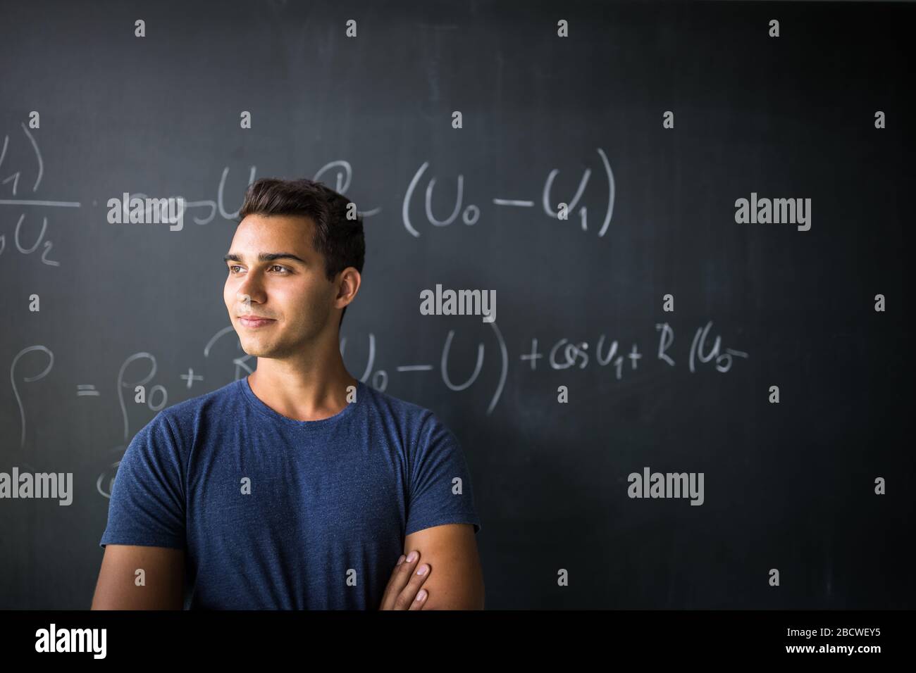 Students in a classroom - handsome student solving a math problem on a ...